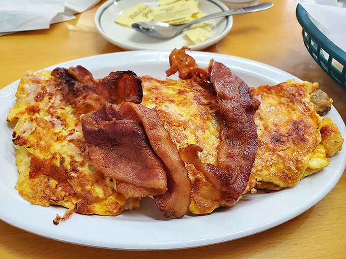 Morning bliss arrives as fluffy eggs meet crispy bacon, creating a breakfast plate that puts hotel buffets to shame.