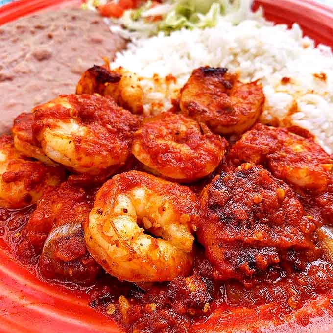 These camarones a la diabla aren't just spicy – they're a masterclass in balanced heat, where plump shrimp swim in a sauce that dances between smoky and sweet.