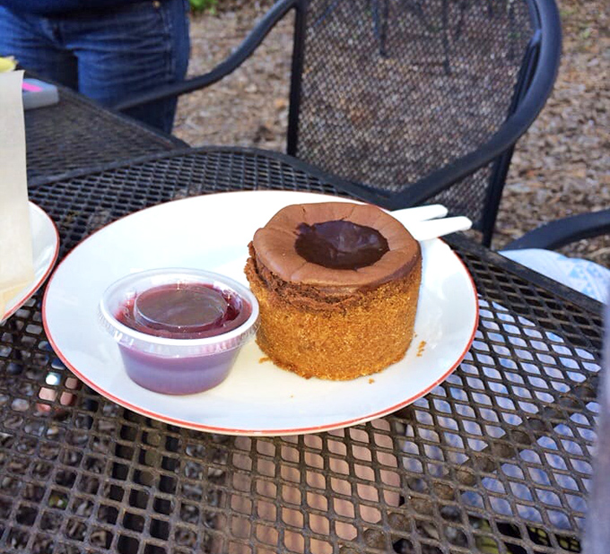 A chocolate cake with a center depression filled with ganache sits like a decadent little volcano waiting to erupt with flavor.