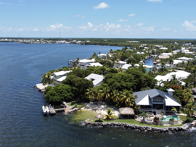 Waterfront luxury nestled among palm trees and mangroves – where morning coffee comes with million-dollar views and pelican fly-bys.