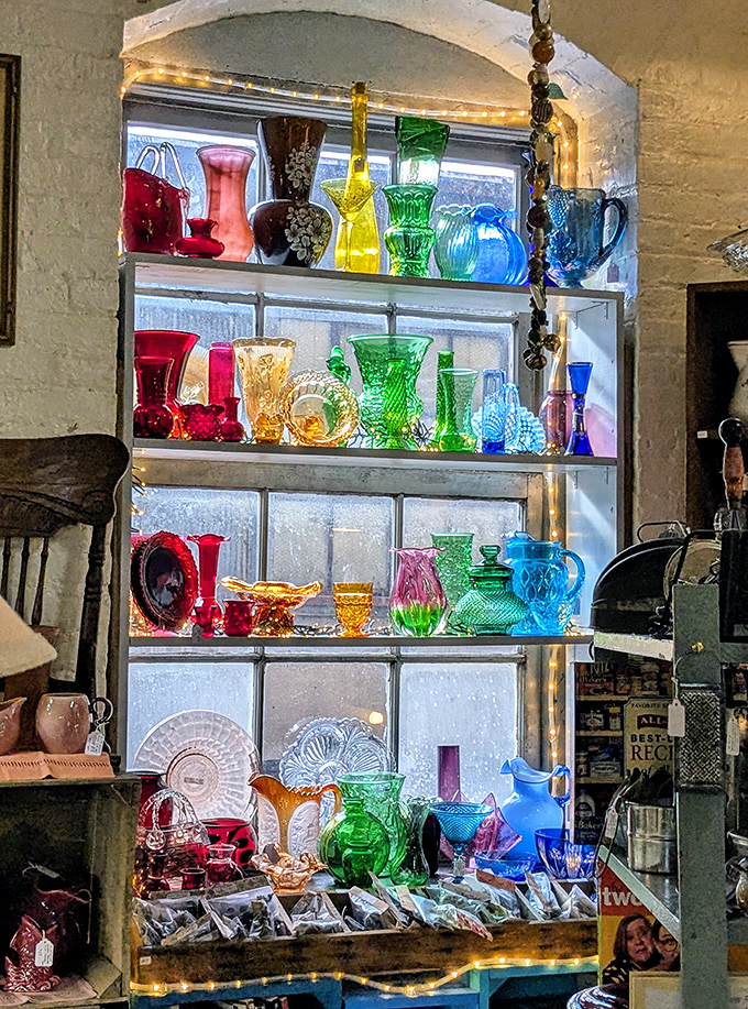 Sunlight plays through vintage glassware creating a kaleidoscope effect. Each piece whispers cocktail party stories from decades past.