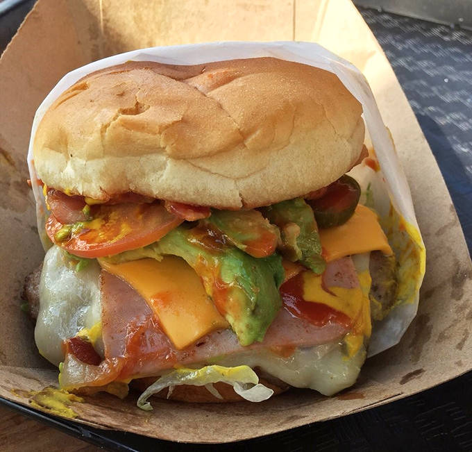 Del Gordo Burger: Avocado, cheese, and fresh veggies cascade from this burger masterpiece—proof that sometimes more really is more.
