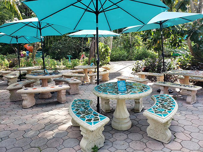 Turquoise tables under matching umbrellas create the perfect tropical oasis for resting weary feet and contemplating whether you could fit that palm tree in your carry-on.