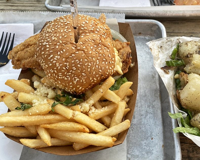 Golden fries dusted with parmesan alongside a burger that would make even seafood purists consider a detour from the ocean.