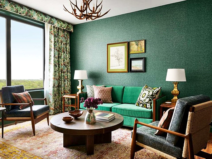 Rich emerald walls and buffalo plaid accents create a guest room that's part luxury hotel, part sophisticated cabin getaway.