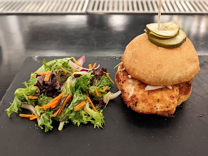 The Hot Honey Chicken Sandwich brings sweet heat to perfectly fried chicken, served with fresh greens on a pillowy bun.
