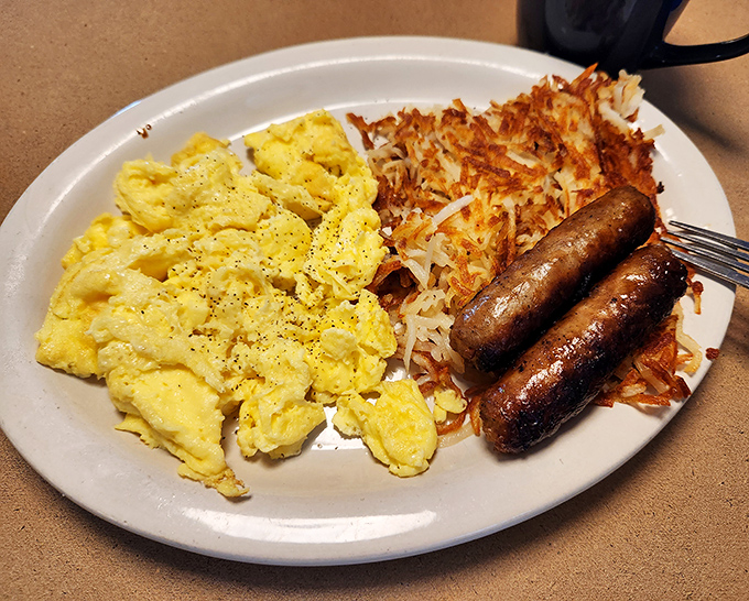 I Wanna Hold Your Hash: Crispy hash browns share the spotlight with perfectly cooked eggs and savory sausage links – a breakfast that performs like a well-rehearsed band.
