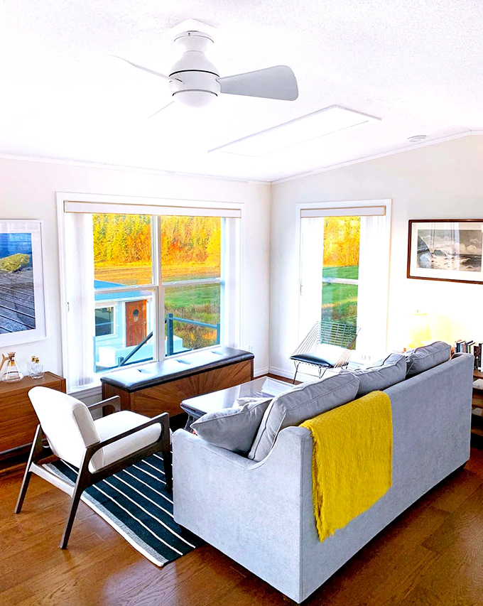 Mid-century modern meets maritime in this thoughtfully designed living space where every window captures Maine's coastal magic.