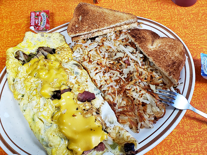 This isn't just an omelet—it's a cheese-filled masterpiece with perfectly distributed fillings that somehow tastes even better than it looks.