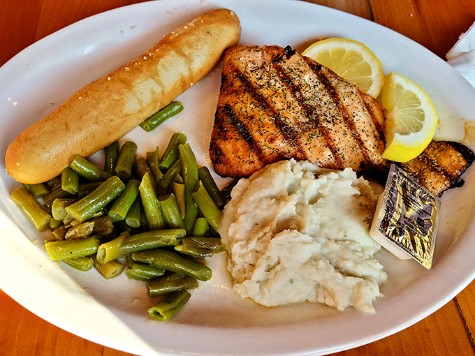 Perfectly grilled salmon that makes you wonder if the fish in the tanks are plotting a jailbreak after witnessing this delicious betrayal.