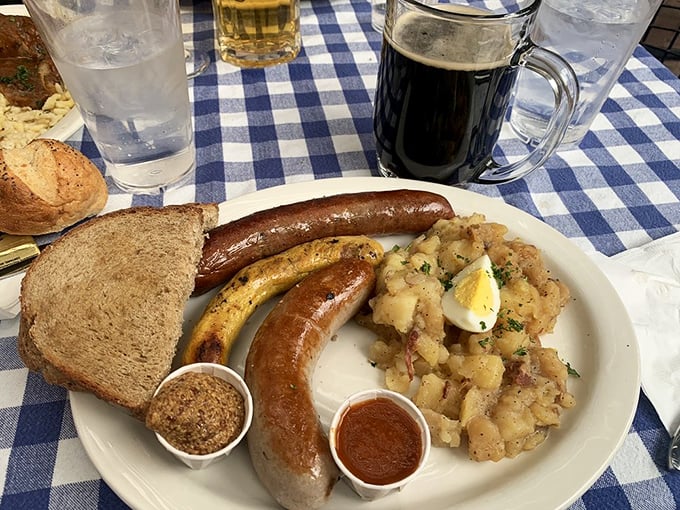 A sausage trio that deserves its own parade, accompanied by potato salad that steals the spotlight. This plate practically yodels with flavor!
