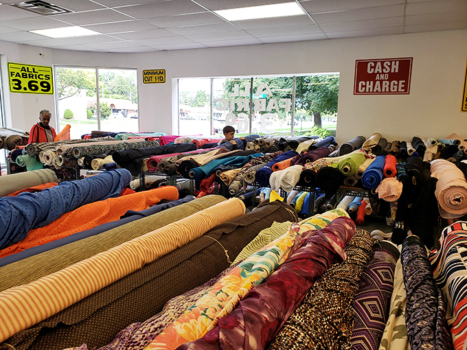 Shoppers navigate the fabric forest with purpose and wonder, each on their own treasure hunt for that perfect textile at an unbeatable price.