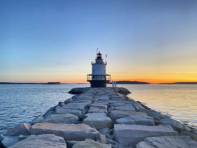 Spring Point Ledge Lighthouse awaits at the end of a rocky breakwater journey, rewarding adventurous visitors with sunset silhouettes worth every careful step.