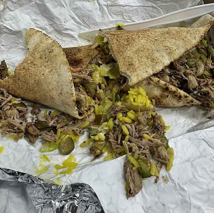 Chicken shawarma wrapped up tight with all the fixings, ready to challenge your jaw's structural engineering capabilities.