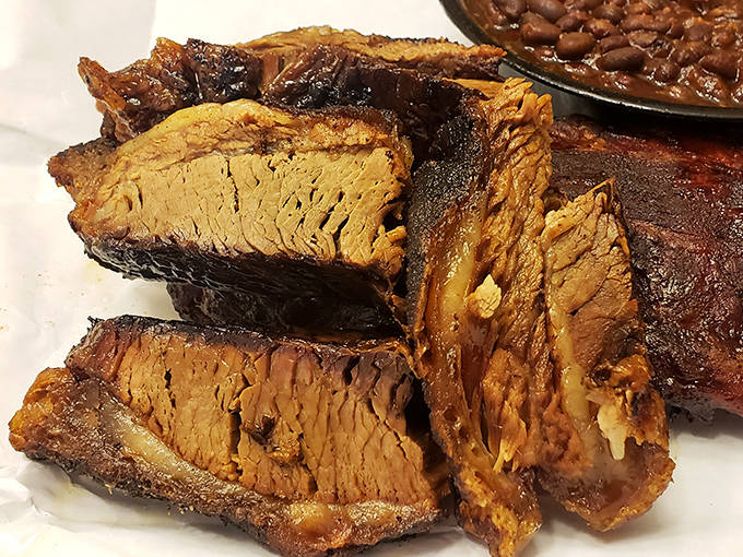 Brisket sliced to reveal that coveted pink smoke ring and perfectly rendered fat that melts on your tongue like savory butter.