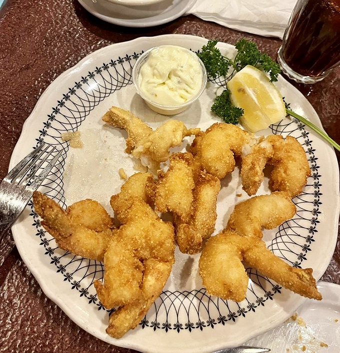 Golden-fried shrimp that snap with each bite, arranged like a delicious crown around house-made tartar sauce and a bright lemon wedge.
