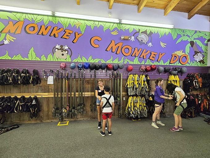 The gear room: where ordinary humans transform into aerial adventurers. The "Monkey C Monkey Do" sign sets the playful tone for what's ahead.