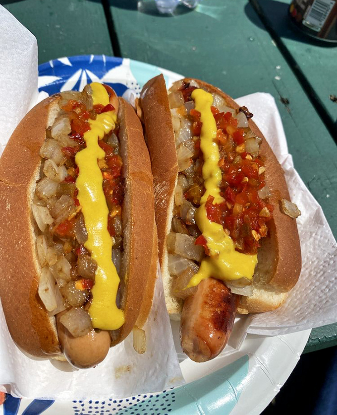 The Western Dog in all its glory &ndash; a symphony of savory sausage, tangy mustard, and perfectly grilled onions nestled in a soft bun.