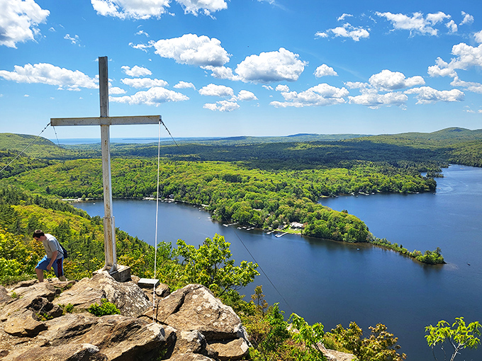 The summit cross stands silently against the sky, a spiritual high point that matches the physical one beneath your feet.