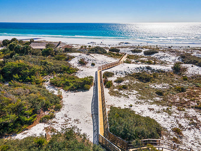 Beach wooden boardwalk: Nature's catwalk through towering dunes, where sea oats dance in the breeze and anticipation builds with each step.