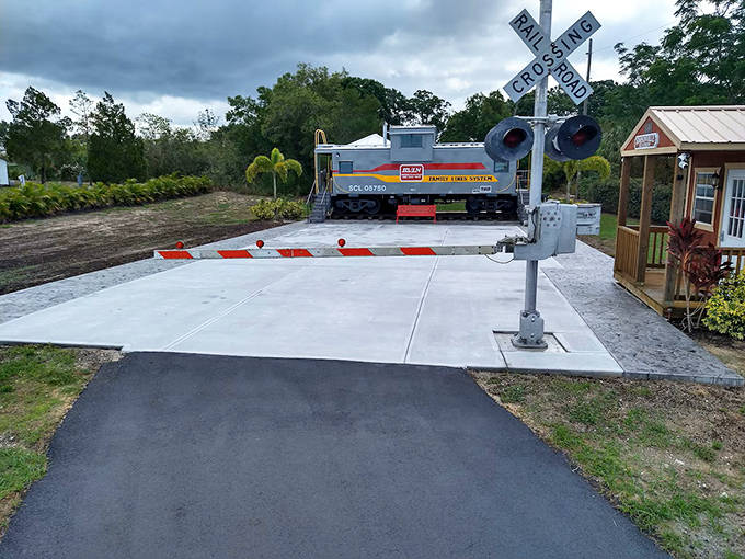 Safety first at the crossing! The entrance to your caboose escape is marked by classic signals and Florida greenery.