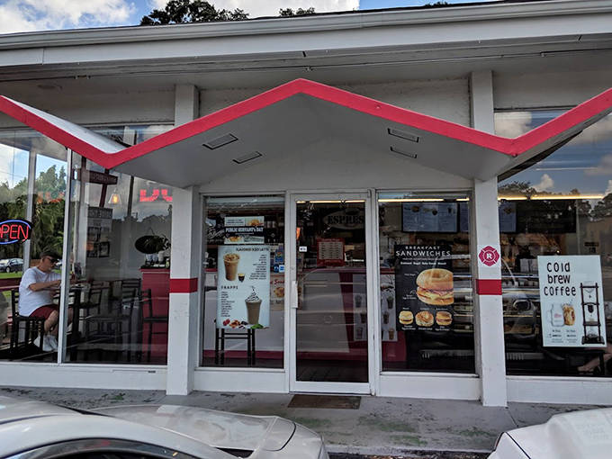 Fray's retro sign reaches skyward, a colorful beacon guiding donut lovers to their drive-thru paradise of classic treats.