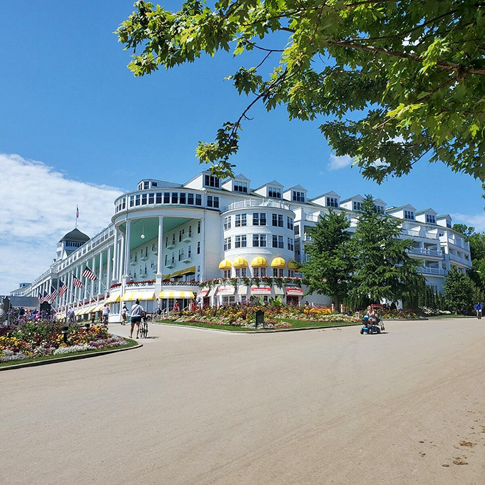 The Grand Hotel's sprawling white facade and vibrant gardens epitomize Mackinac Island's timeless elegance, a Victorian vision preserved in modern times.