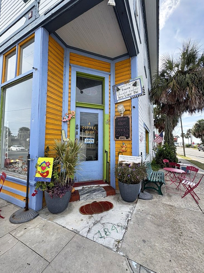 Bright yellow siding, blue trim, and a welcoming green door make the 1842 Daily Grind & Mercantile an irresistible stop for coffee lovers exploring Cedar Key.
