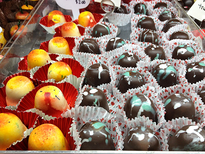 Colorful truffles and chocolate-dipped fruits showcase Oh My Chocolates' artistic approach to confections, with each piece looking almost too beautiful to eat.