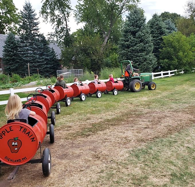 The apple train carries young passengers through orchards in barrel cars, proving that the best transportation doesn't need to break the sound barrier.