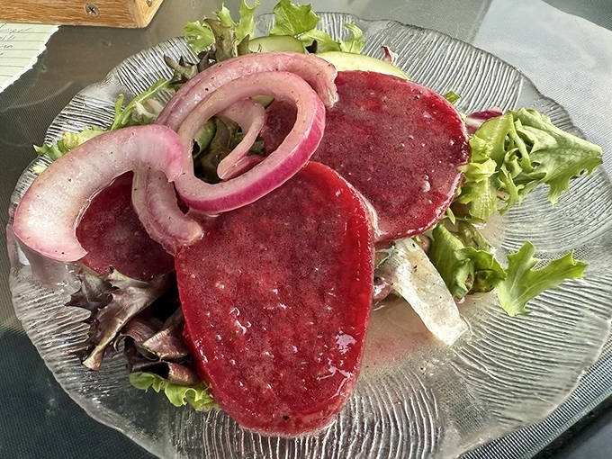 Vibrant beet salad with delicate onion rings &ndash; proof that German cuisine isn't all heavy meats, though nobody's complaining about those either!