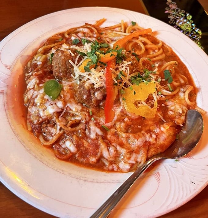 A hearty meat sauce clings lovingly to each strand of pasta, topped with cheese that doesn't come from a green can.