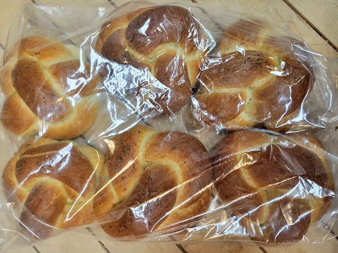 Freshly baked breads and rolls line the shelves, their crusty exteriors hiding the soft, aromatic interiors.