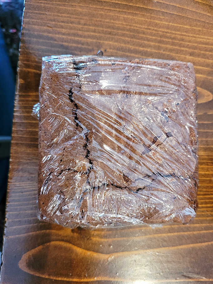 A chocolate brownie wrapped like a present &ndash; because sometimes the best therapy involves both chocolate and cats.