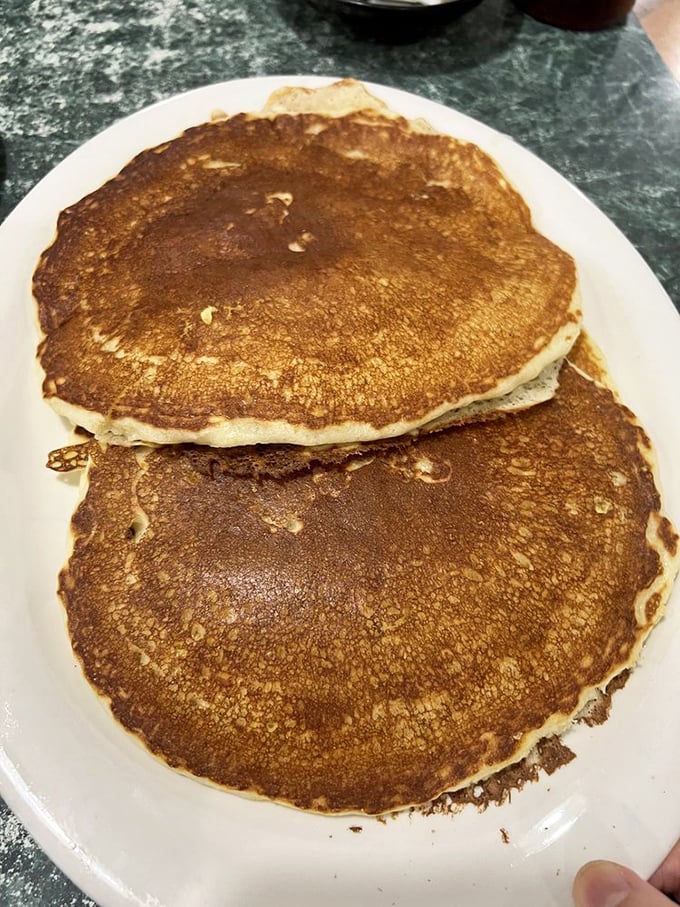 Pancakes at Tony's don't just hang over the edge of the plate – they practically need their own zip code.