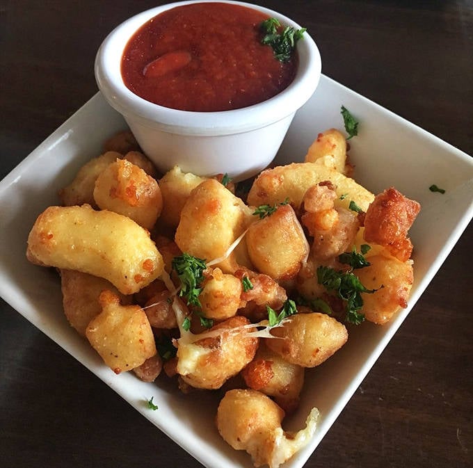 Cheese Curds: Wisconsin might be jealous of these perfectly fried cheese curds &ndash; little clouds of dairy heaven with a marinara dipping companion.