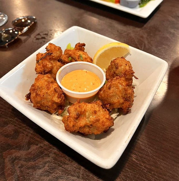 Conch Fritters: Little golden globes of Key West tradition, crispy-edged and tender-centered, begging to be dunked in that zesty mustard sauce.