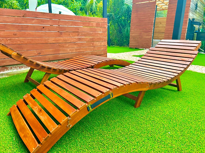 These curved wooden loungers practically whisper "afternoon nap" in a voice too tempting to ignore.
