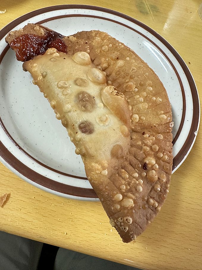 This golden half-moon pastry shatters perfectly, revealing seasoned filling that makes you wonder why you'd eat anything else.