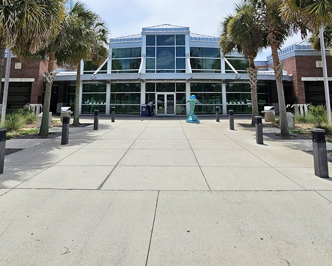 The modern welcome center gleams in the Florida sunshine, a glass-fronted oasis promising air conditioning and insider tips.