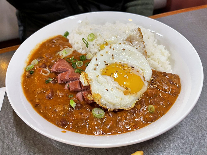 The Hawaiian chili plate brings mainland comfort food to new heights with tender beef, savory gravy, and that perfectly runny egg.