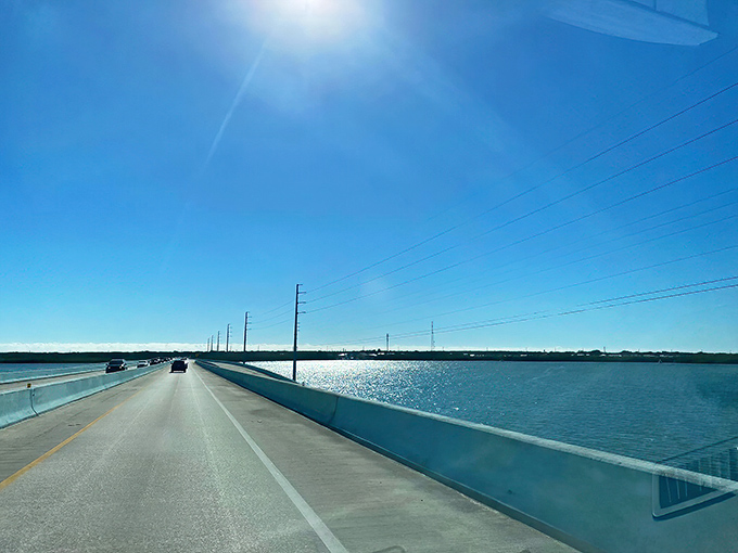 The legendary Overseas Highway stretches across impossible shades of blue, connecting the Florida Keys like a necklace of tropical pearls.
