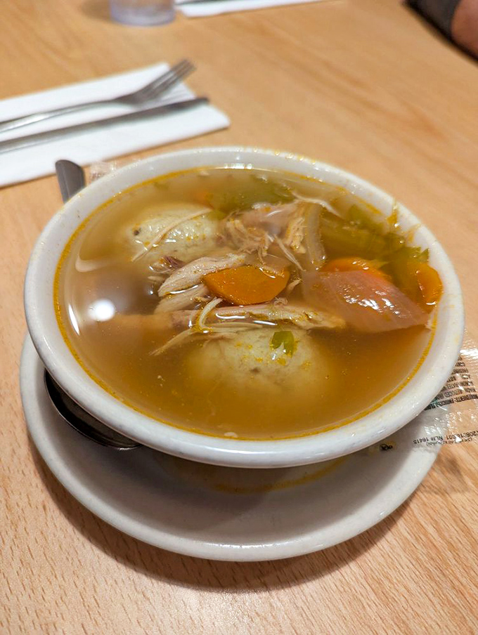 Matzo ball soup that could cure anything &ndash; golden broth clear enough to read through, with a matzo ball that defies physics.
