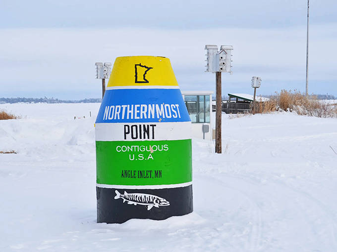 Winter transforms the Northernmost Point monument into a snow-capped landmark amid Minnesota's frozen landscape.