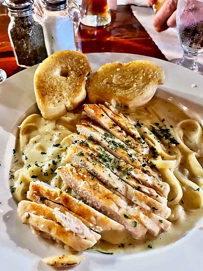 Fettuccine that would make an Italian grandmother nod in approval, topped with perfectly grilled chicken and served with garlic bread for sauce-sopping.