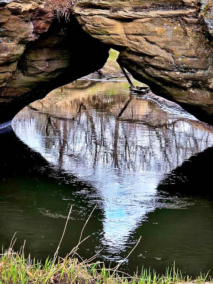 Nature's perfect frame: water-carved sandstone creates windows to another world, patient artistry millions of years in the making.