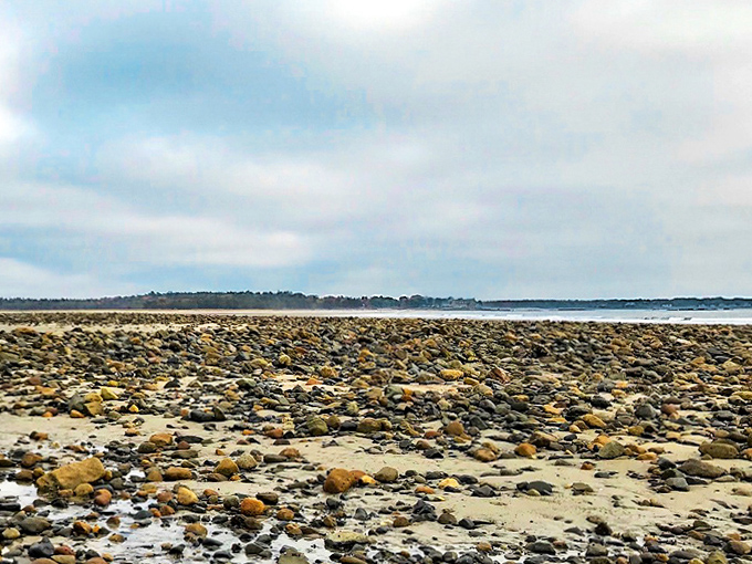 A tapestry of stones blankets the shoreline, each one polished by countless Atlantic waves into smooth perfection.
