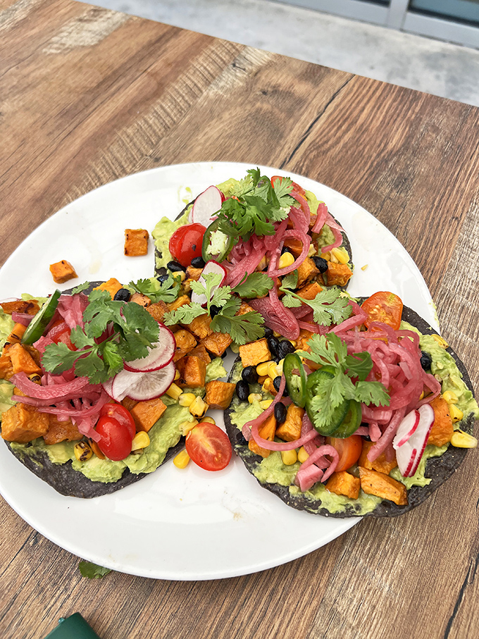 Vibrant tostadas burst with color and flavor – a feast for the eyes and palate that mirrors the botanical diversity just steps away.