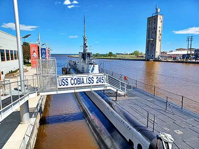 The USS Cobia stretches 312 feet along the waterfront, her black hull a stark reminder of the stealth and danger that defined submarine warfare.