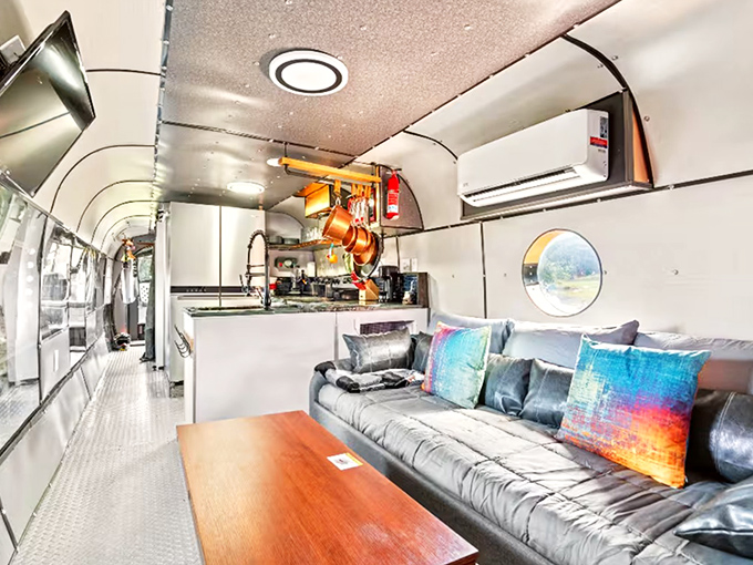 Who knew a helicopter could house such a stylish living room and fully-equipped kitchen? Not your average camping experience!